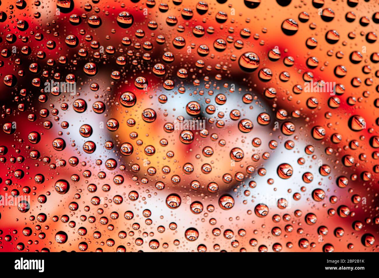 Female eye through drops of water on glass Stock Photo - Alamy
