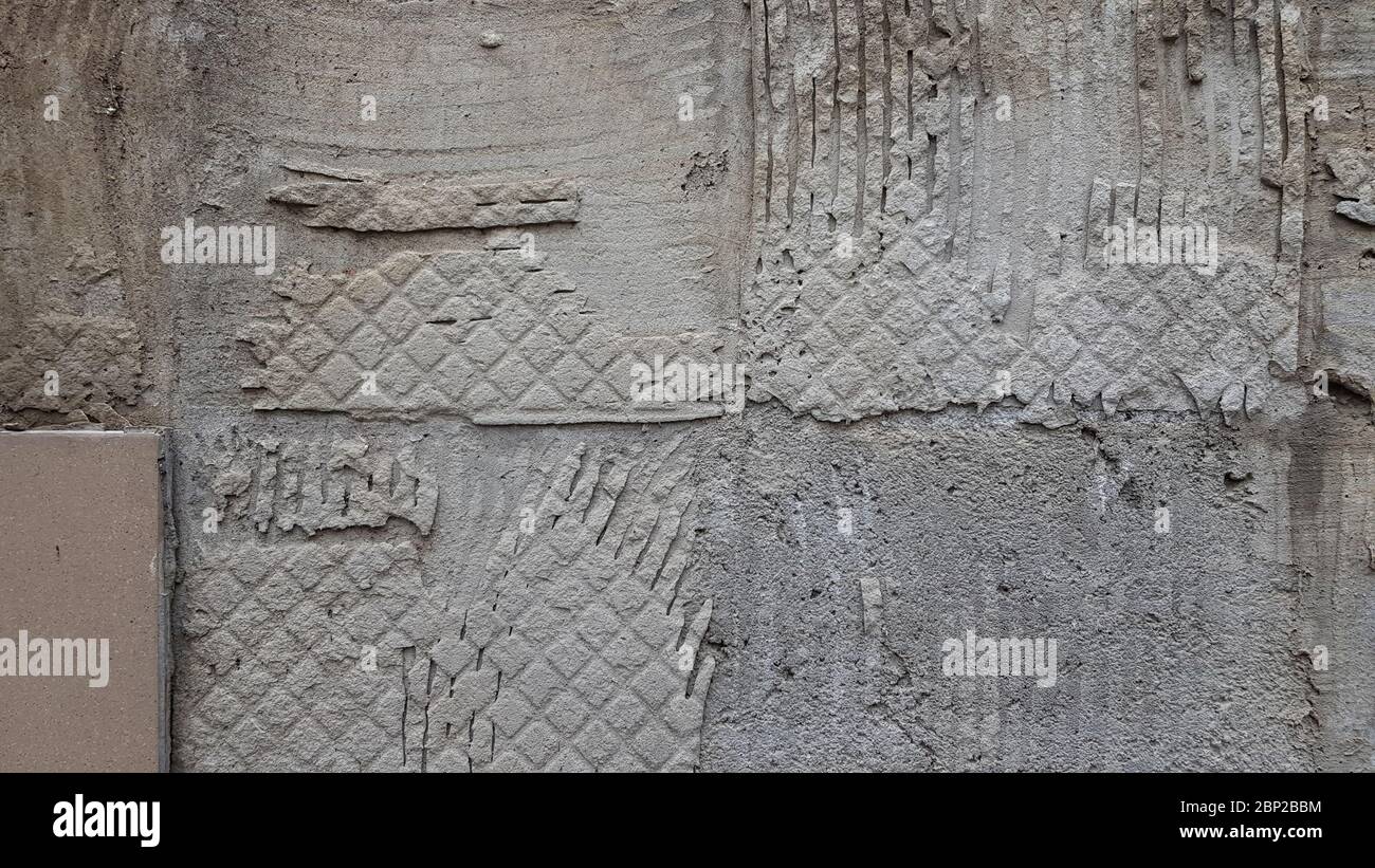Scratched rough texture of grey cement prepared for under wall tiles ...