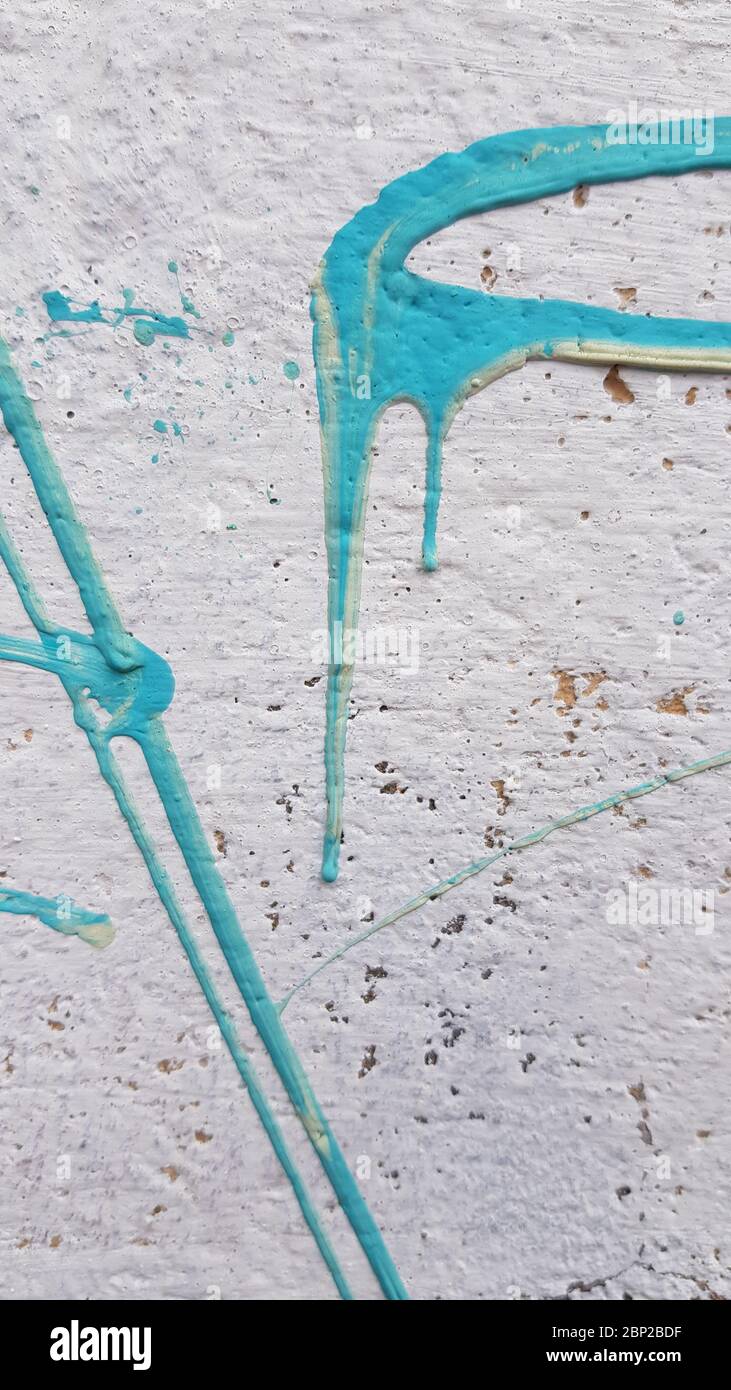 Closeup of blue dripping paint droplets. Strokes of light blue paint on ...