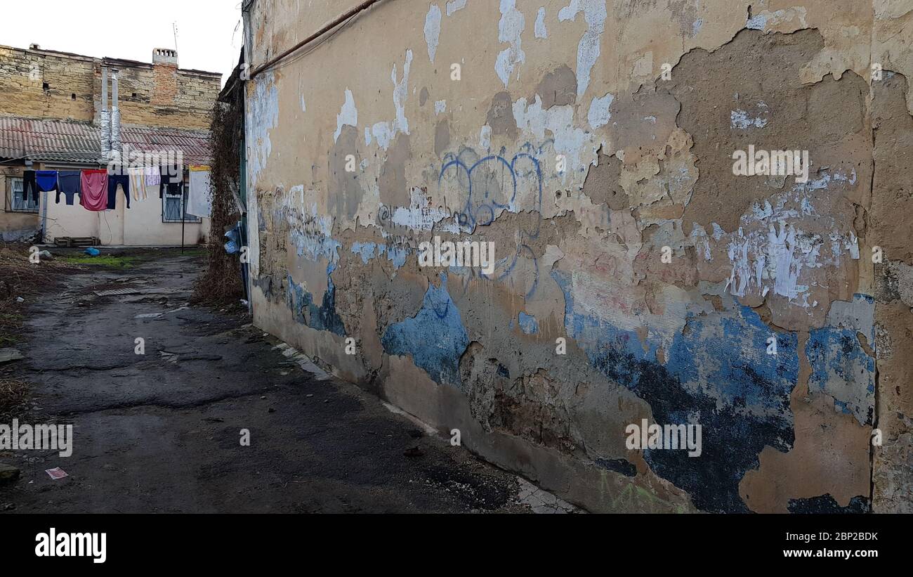 Ghetto court yard with hanging laundry clothes and weathered wall on ...