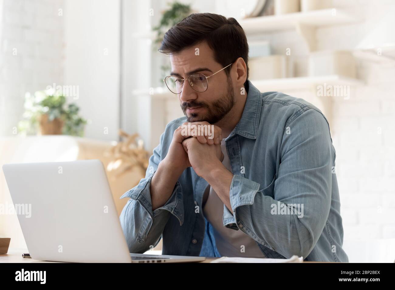 Pensive caucasian guy thinking home hi-res stock photography and images ...