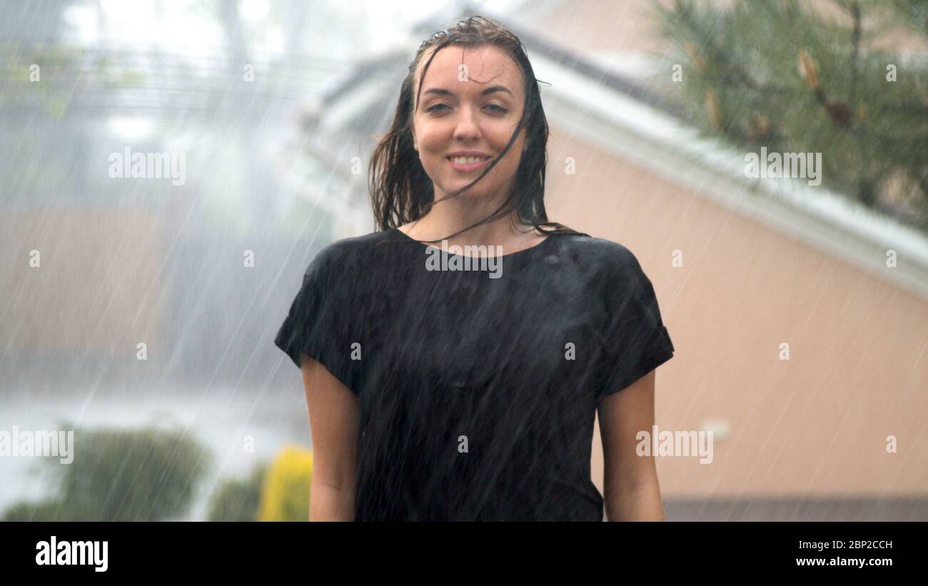 Young woman enjoying rain in garden at raining day Stock Photo - Alamy