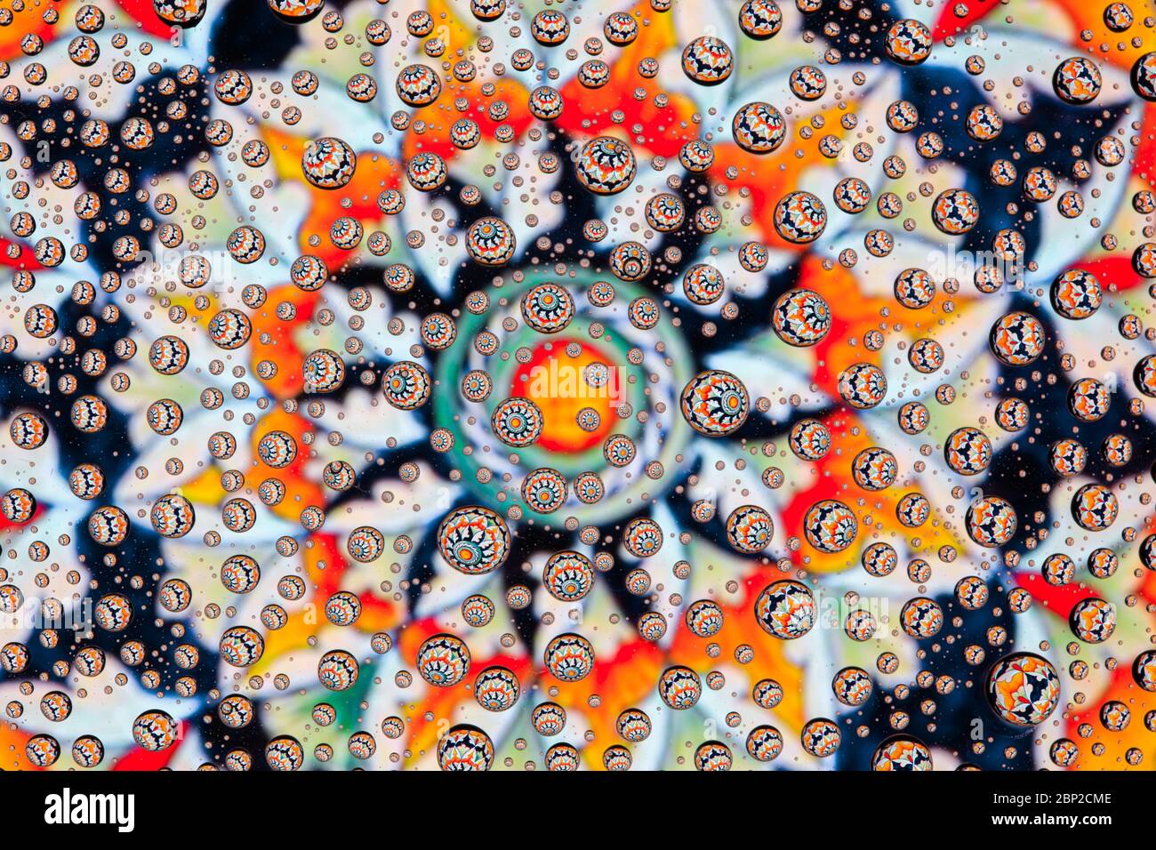 multi-colored mandala through drops of water on glass Stock Photo - Alamy