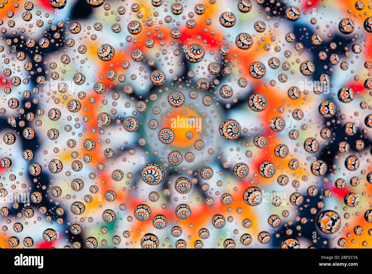 multi-colored mandala through drops of water on glass Stock Photo - Alamy