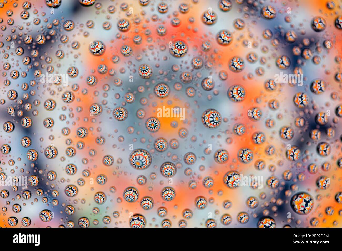 multi-colored mandala through drops of water on glass Stock Photo - Alamy