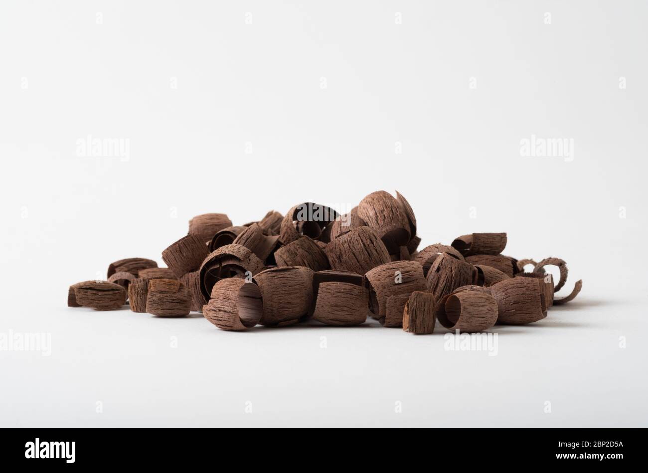 A collection of walnut wood shavings from carving, photographed against ...