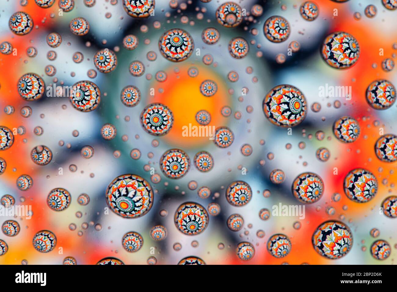 multi-colored mandala through drops of water on glass Stock Photo - Alamy