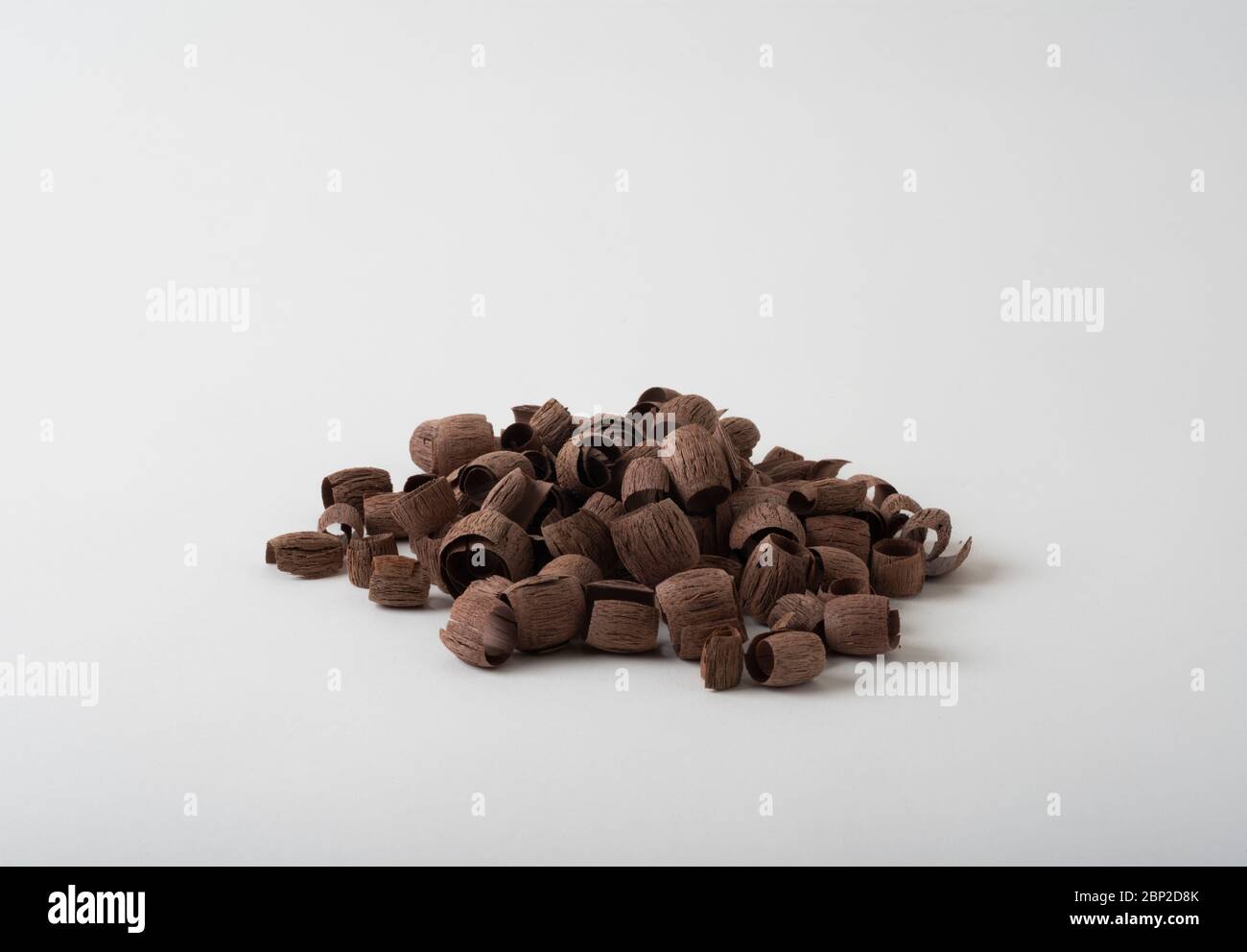 A collection of walnut wood shavings from carving, photographed against ...