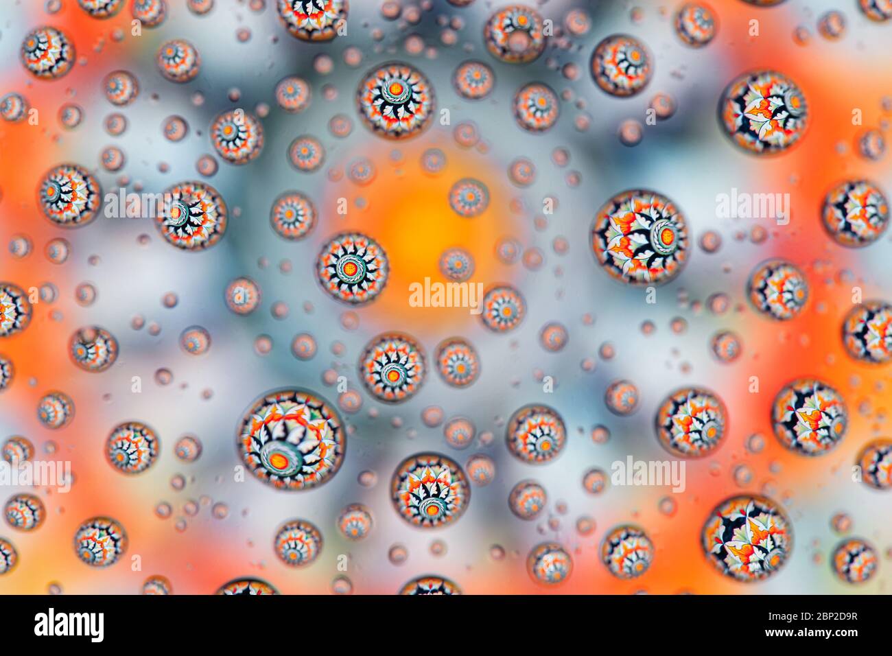 multi-colored mandala through drops of water on glass Stock Photo - Alamy