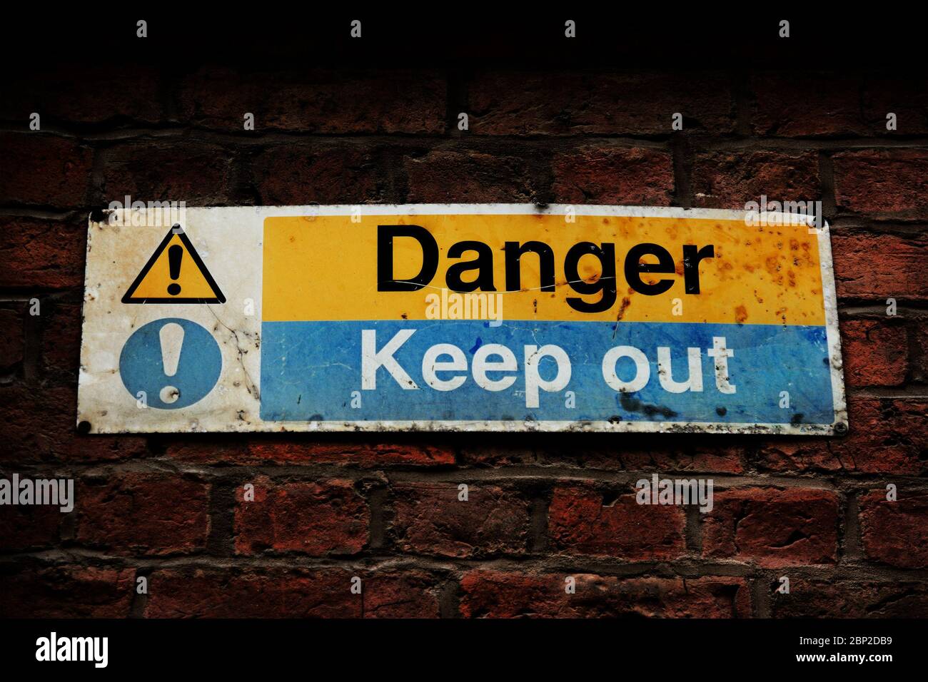 An old Danger Keep out sign on a red brick wall Stock Photo - Alamy