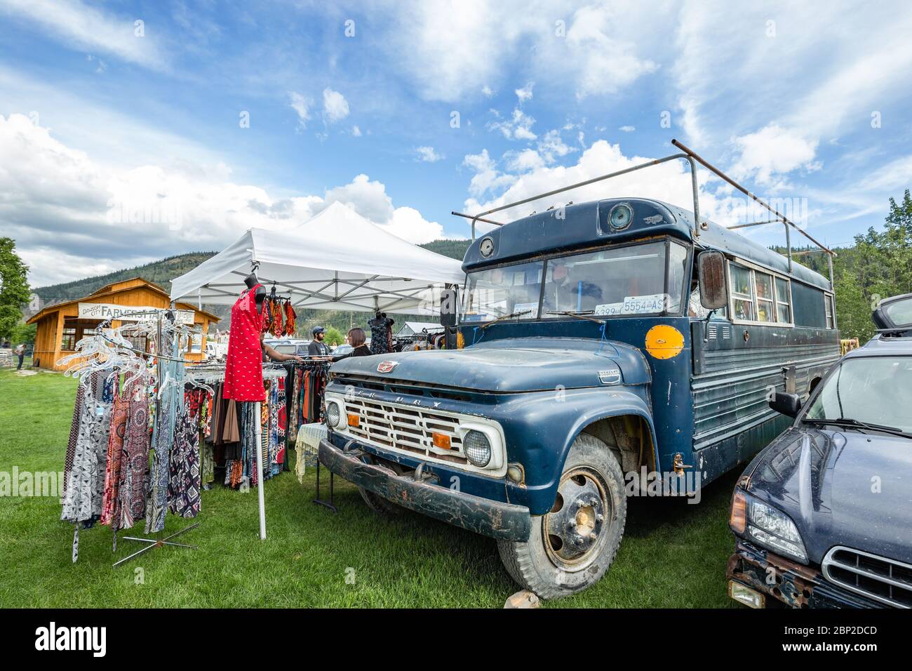 Artsy bus is part of a clothing vendor's display at art fair/farmers ...