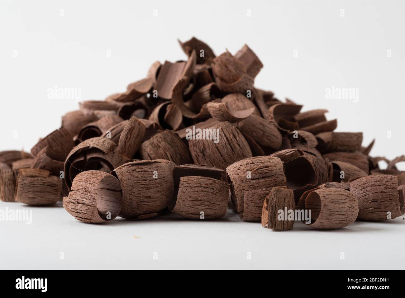 A collection of walnut wood shavings from carving, photographed against ...