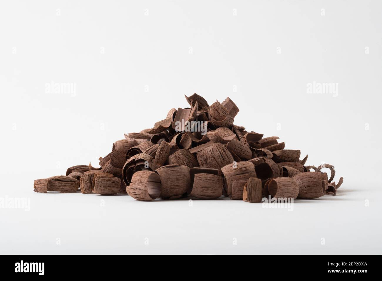 A collection of walnut wood shavings from carving, photographed against ...