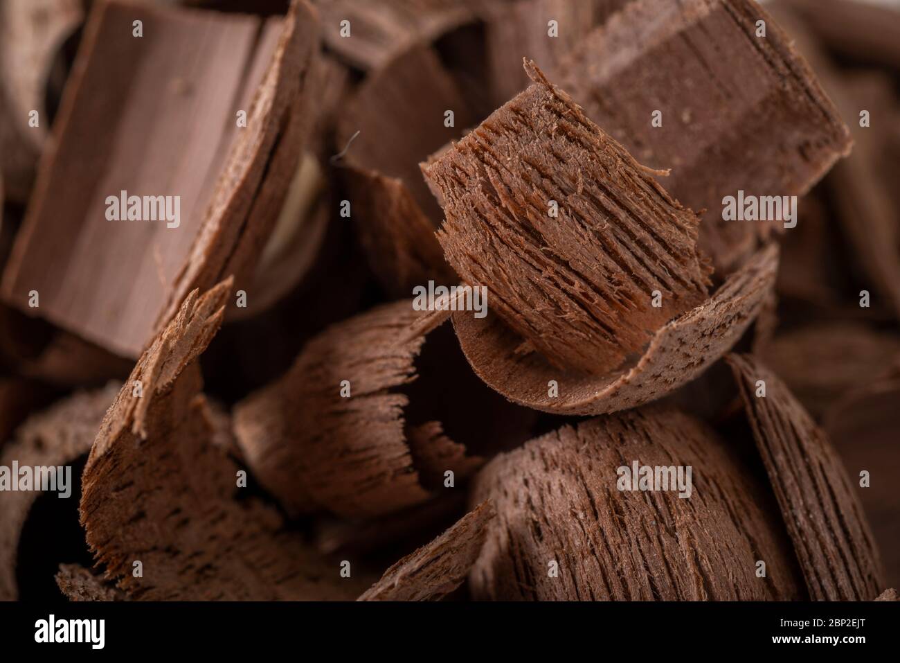 A collection of walnut wood shavings from carving, photographed in a ...