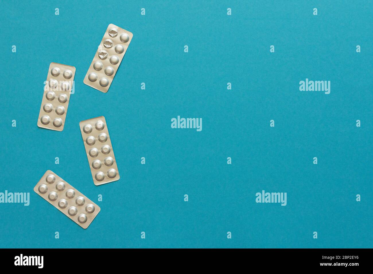 Blister packs with pills on a blue background, lowering blood ...