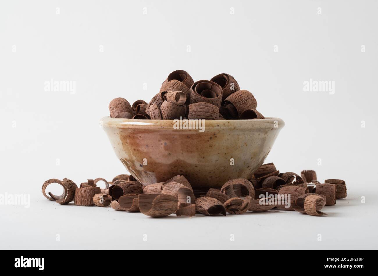 A collection of walnut shavings from carving, collected in a small ...