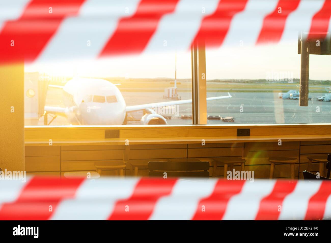 Aairport gate and plane closed with warning tape Stock Photo - Alamy