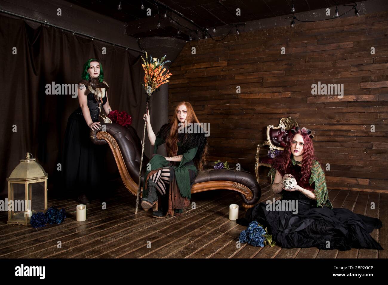 Three beautiful women with brightly colored hair pose as witches, or ...