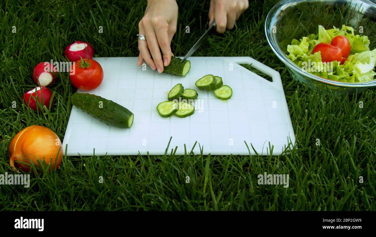 Woman fresh cucumber in garden green grass Stock Photo - Alamy