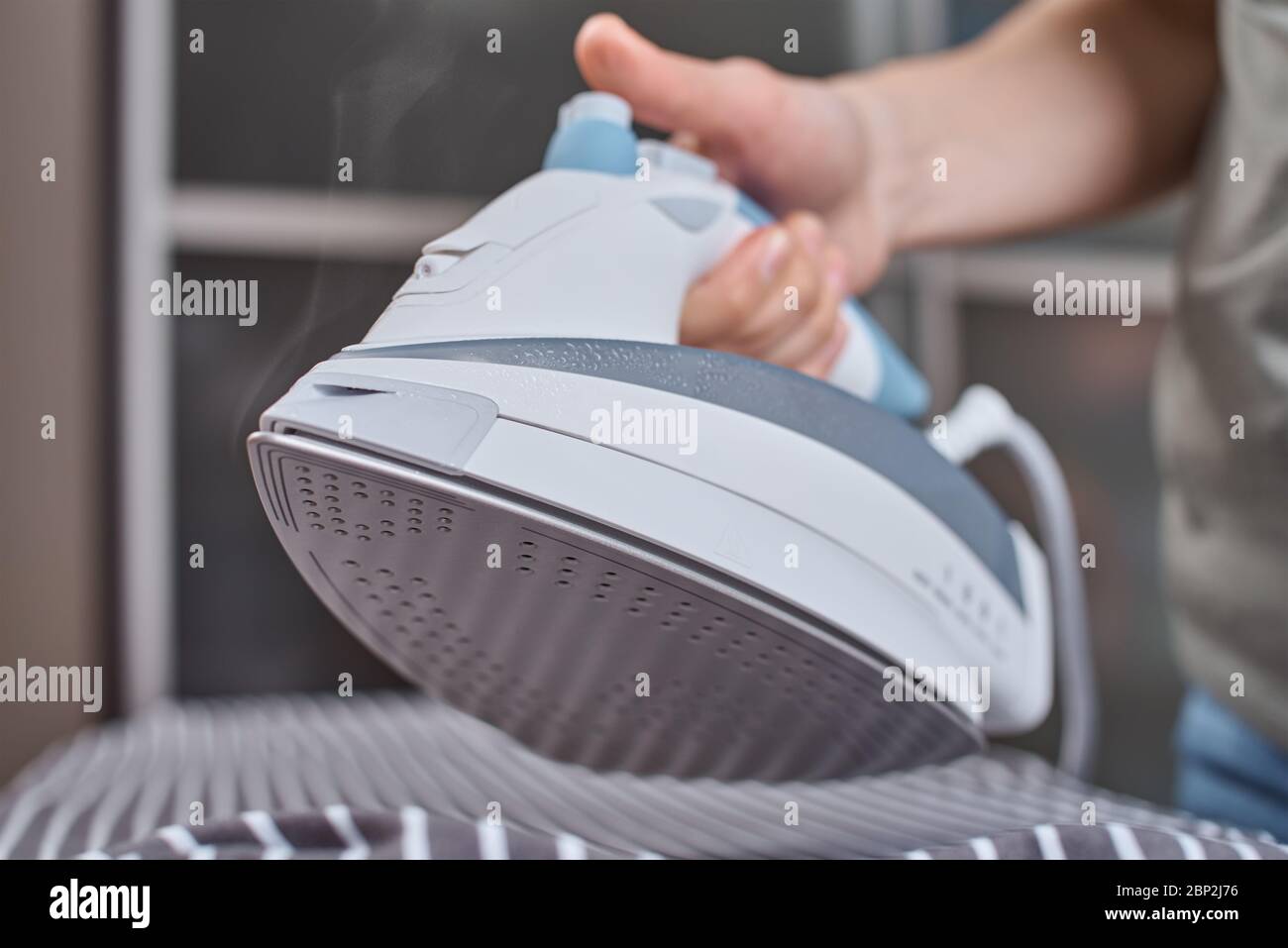 Woman ironing using steam iron hi-res stock photography and images - Alamy