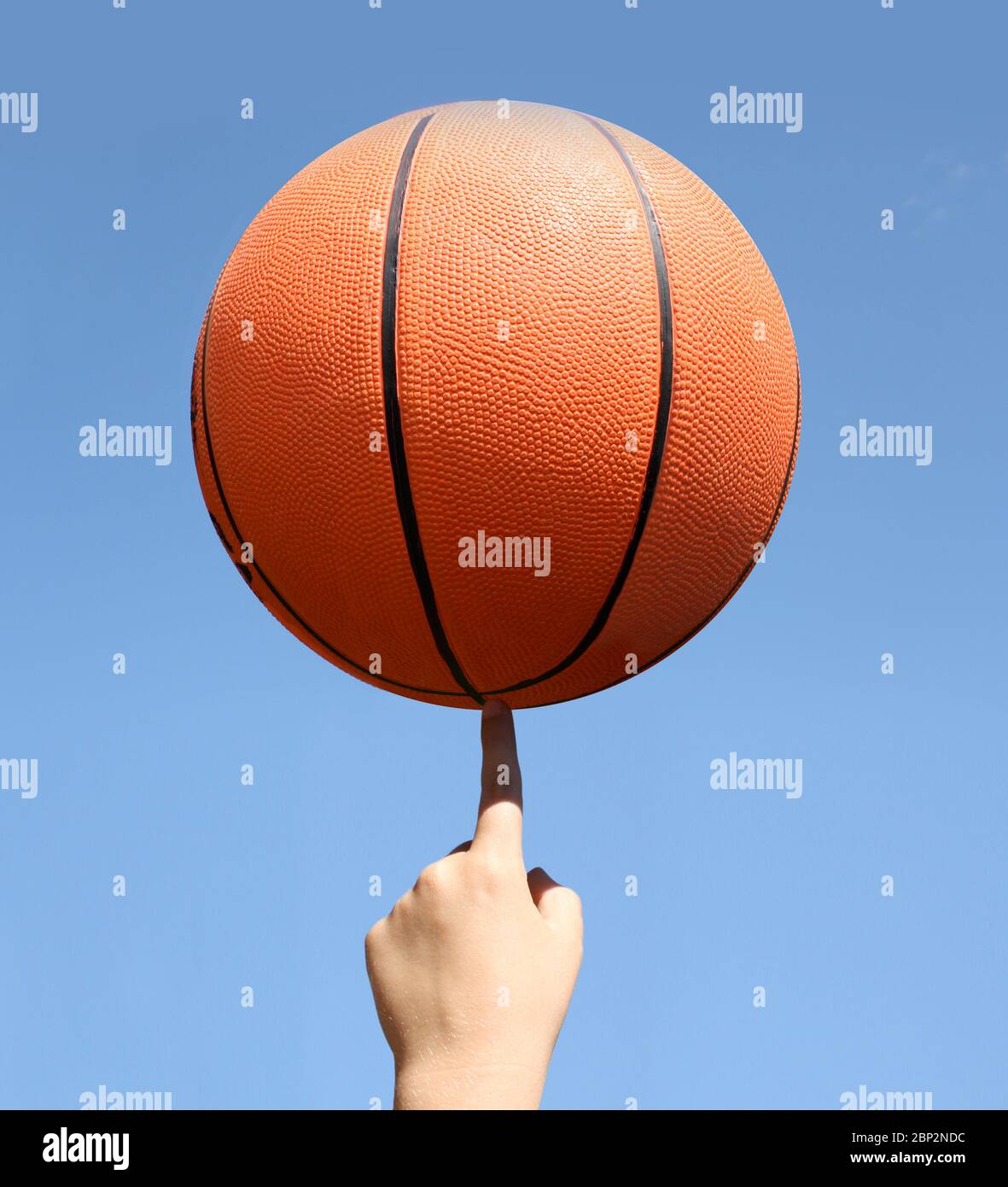 Basketball balanced on finger Stock Photo - Alamy