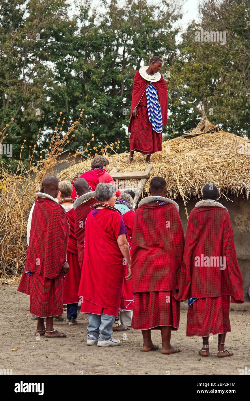 Maasai village; women, indigenous people; visitors, traditional dress ...