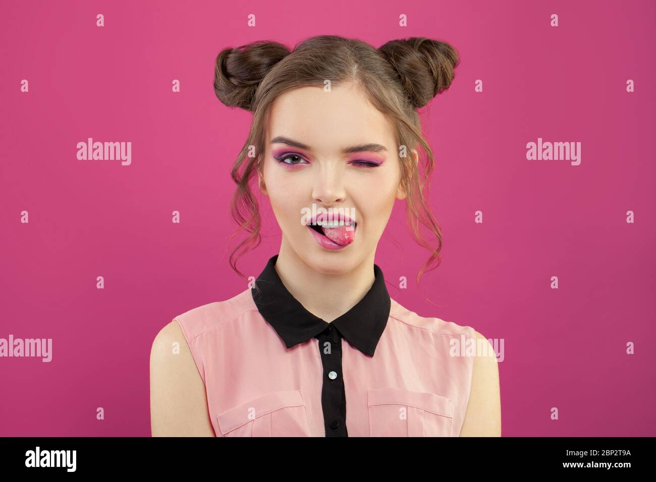 Nice funny model woman with fashion makeup on bright pink background ...