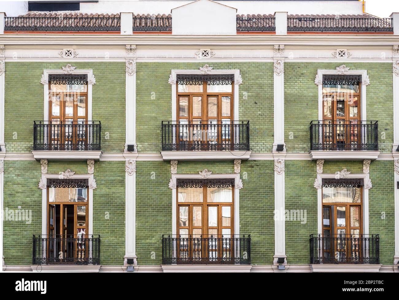 several windows of old apartment residential building of the early ...