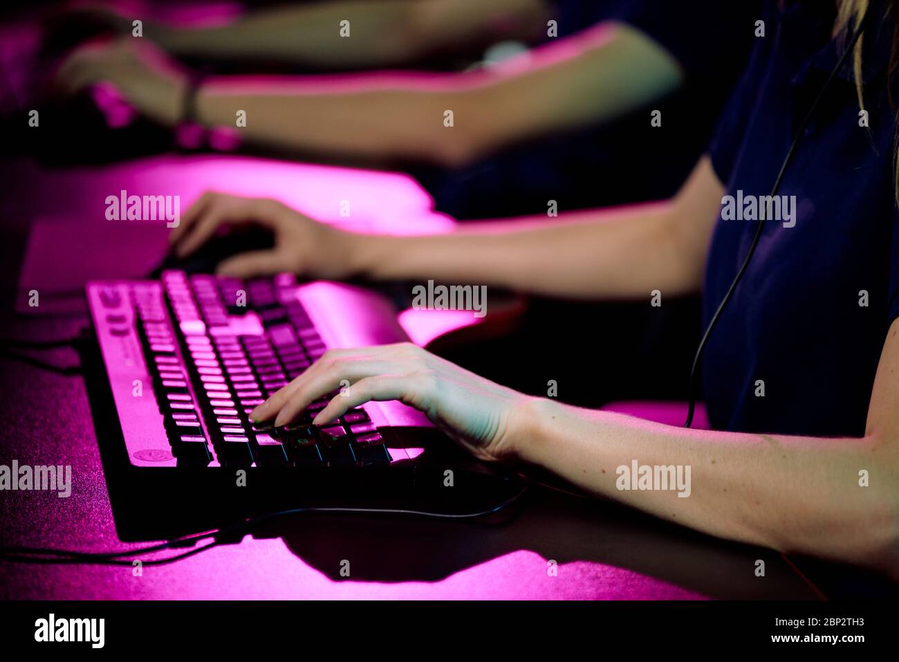 Hands of young female operator of call center touching keys of computer ...