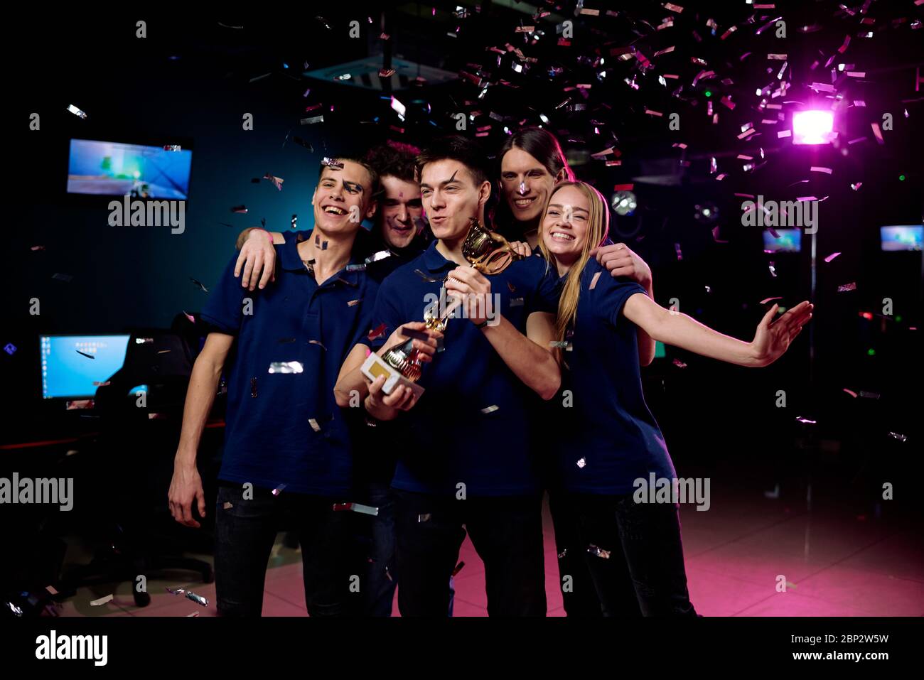 Group of five teenagers celebrating their victory in cybersports ...
