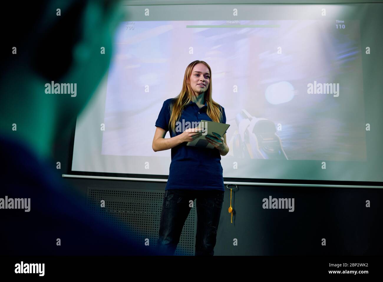 Young confident female developer of new network video game with digital ...