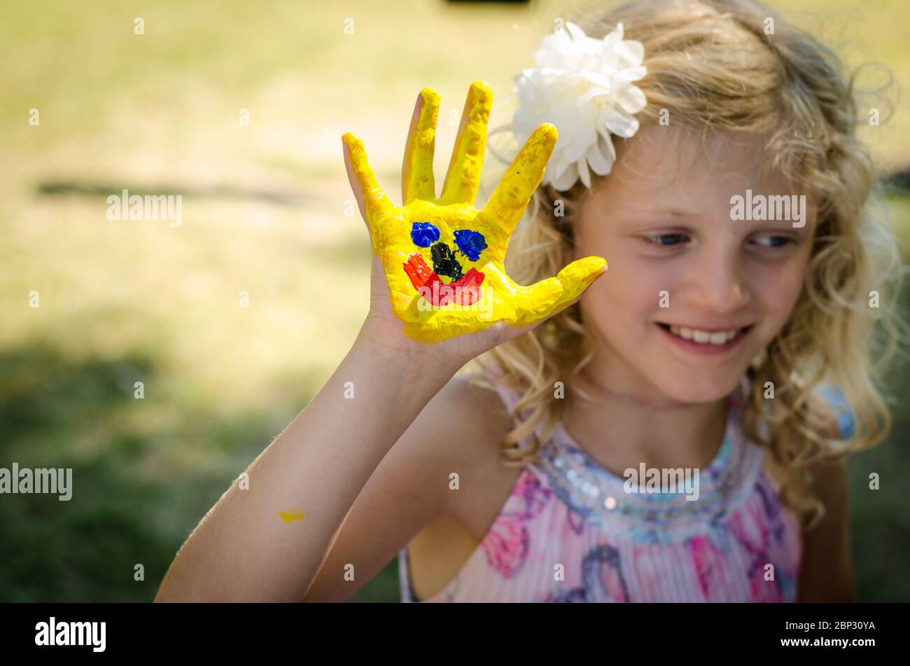 happy smiling child with colorful image on her hand and fingers Stock ...