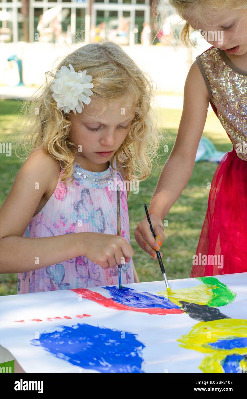 two blond girl having fun with colors Stock Photo - Alamy
