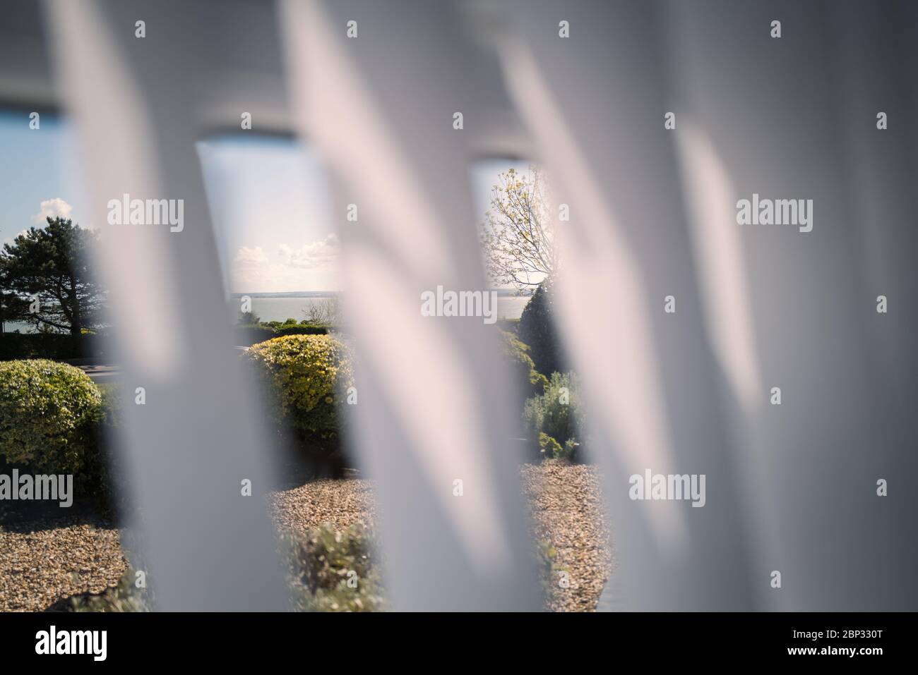 Front garden or front yard with a seascape through a window through ...
