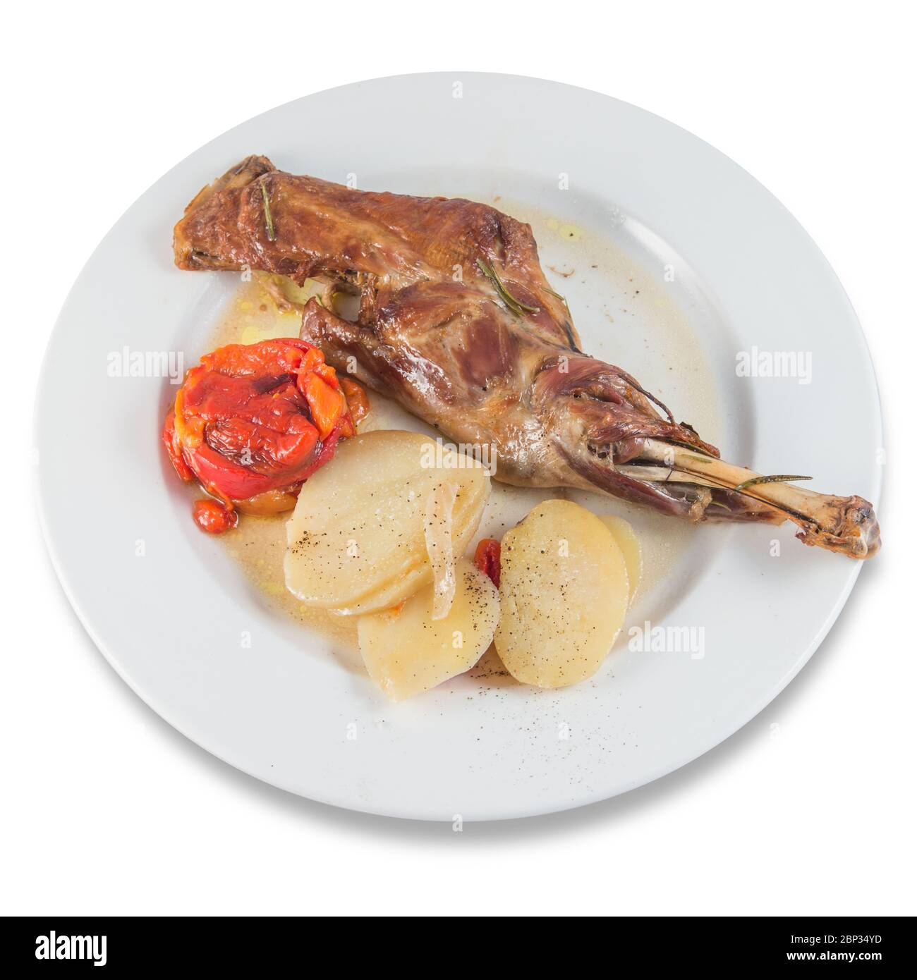 Baked leg of goat, with baked potatoes and roasted red peppers Stock ...