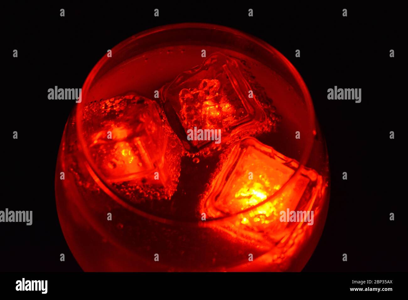 Red bright glowing ice cubes that float in a delicious frosted white ...