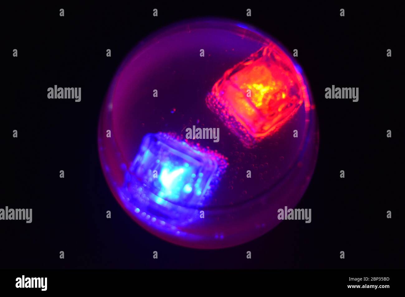 Red and blue bright glowing ice cubes that float in a delicious frosted ...