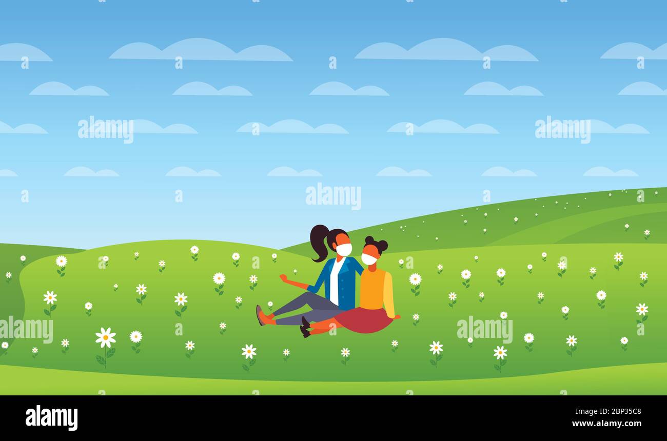 girls sitting on grass women wearing medical masks to prevent ...