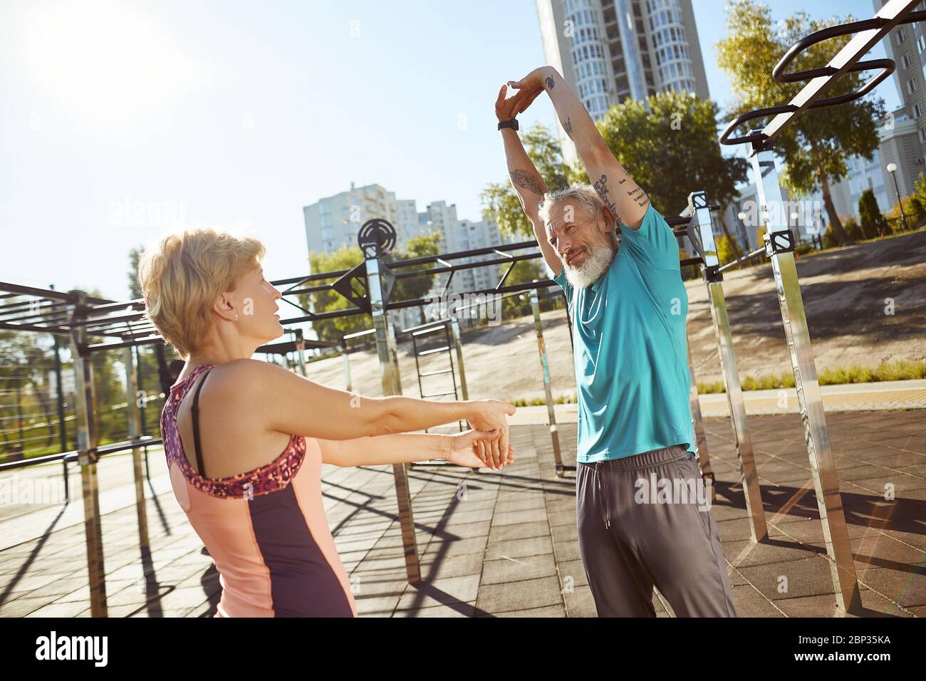 Staying healthy. Active mature family couple in sportswear warming up ...