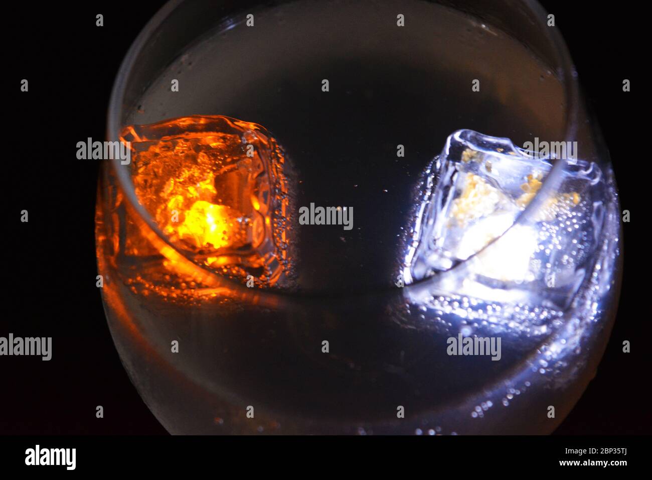 White and yellow bright glowing ice cubes that float in a delicious ...
