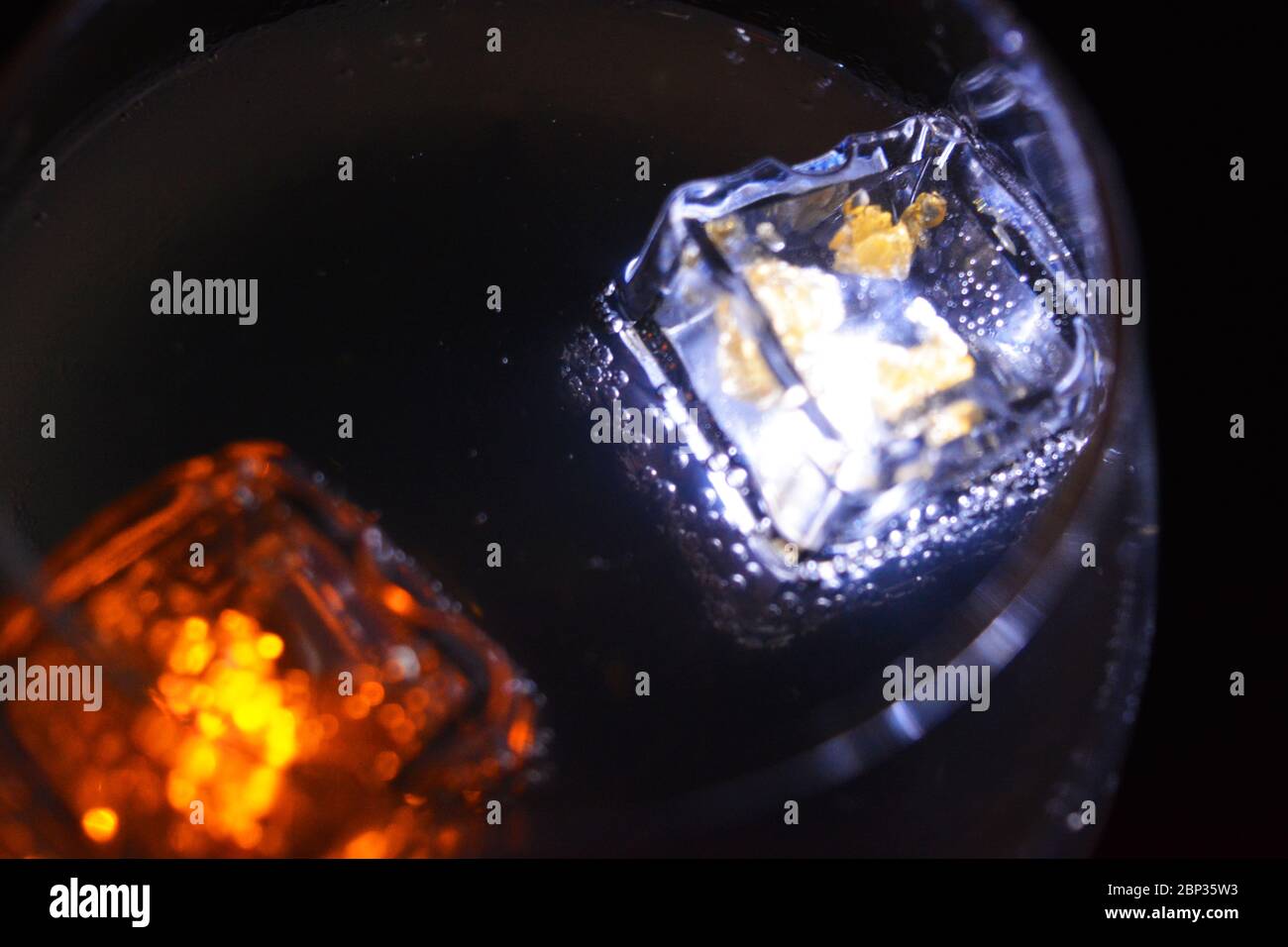 White and yellow bright glowing ice cubes that float in a delicious ...