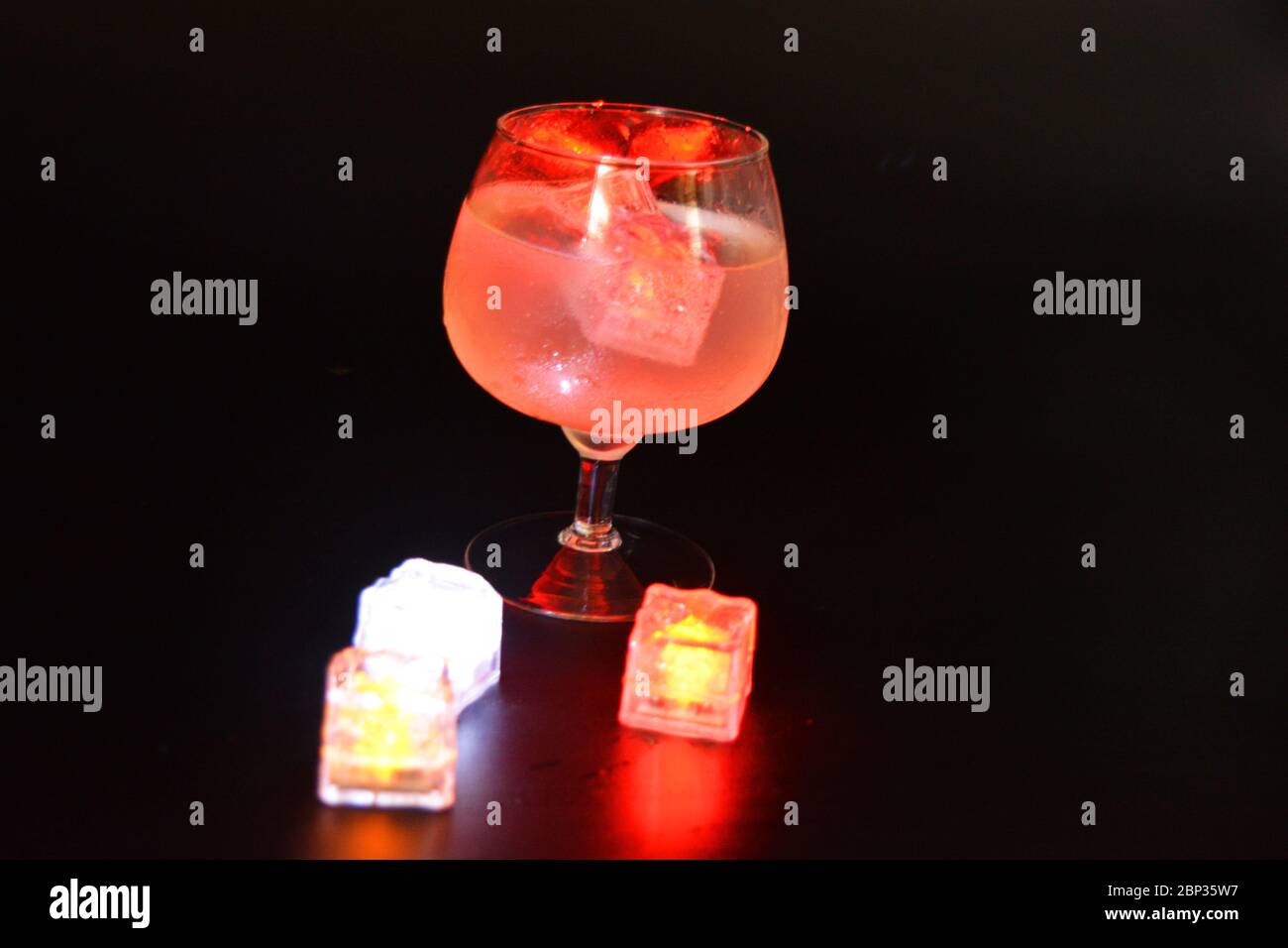 Red bright glowing ice cubes that float in a delicious frosted white ...