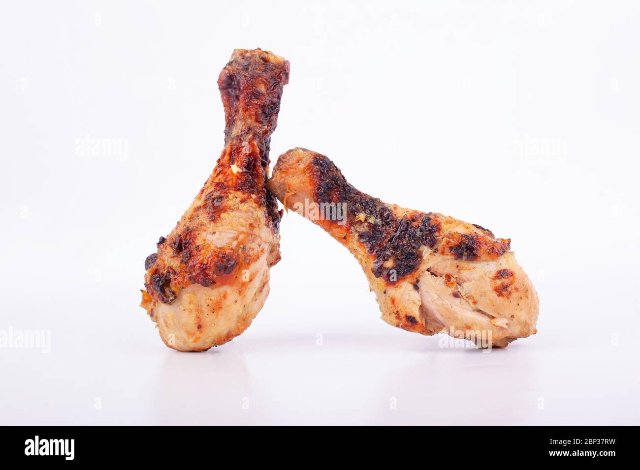 two fried chicken legs on an isolated white background, grilled chicken ...