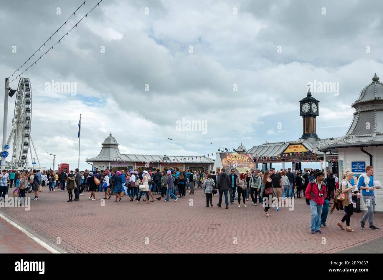 General view of crowds of people at the Brighton Pier main entrance as ...