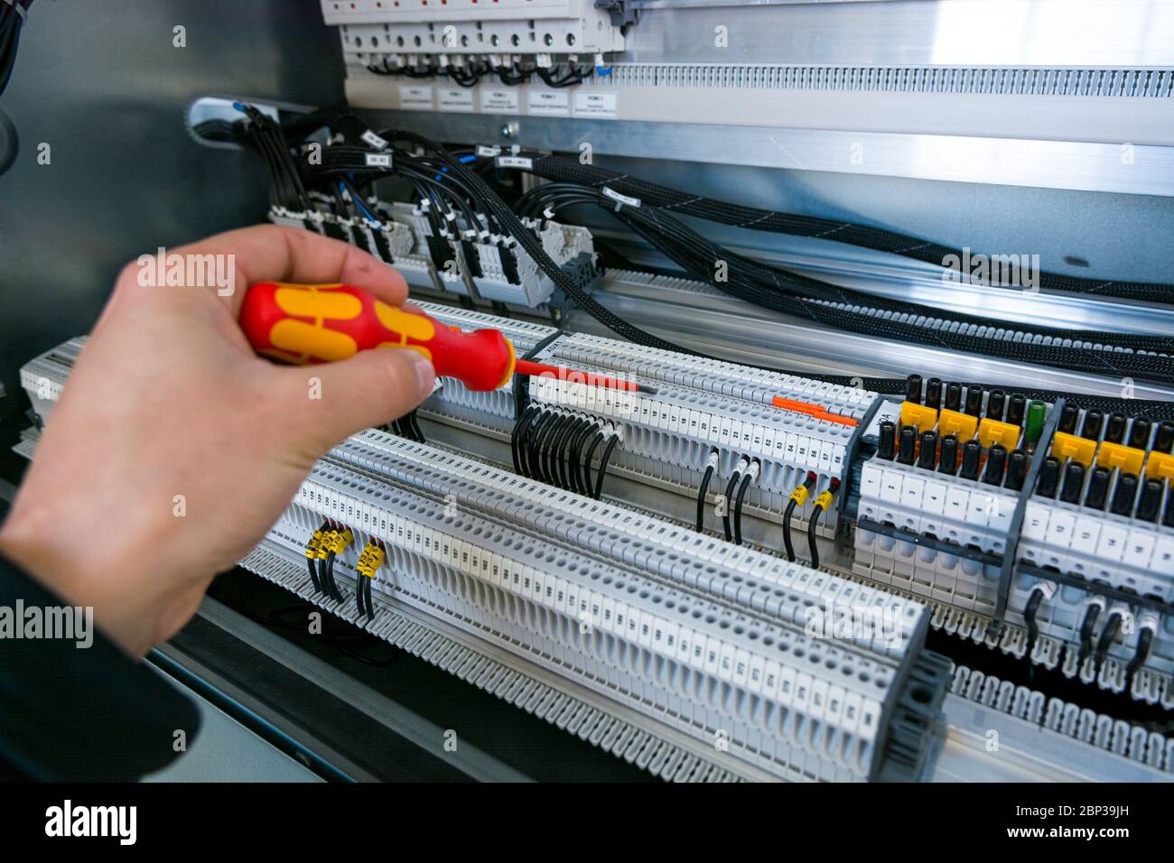 Installing a new connector in electric cubicle Stock Photo - Alamy