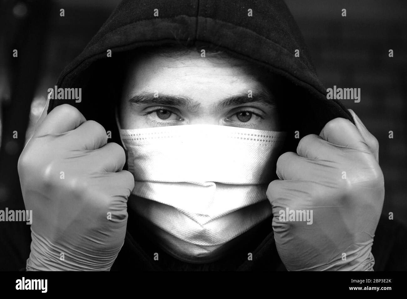 Portrait of young man wearing medical protective face mask for Covid-19 ...