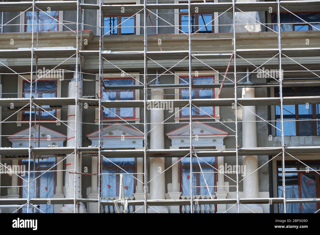 scaffolding at the facade of a building under construction, multi ...