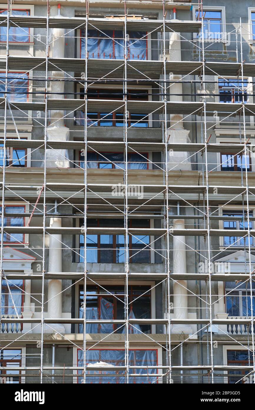 scaffolding at the facade of a building under construction, multi ...