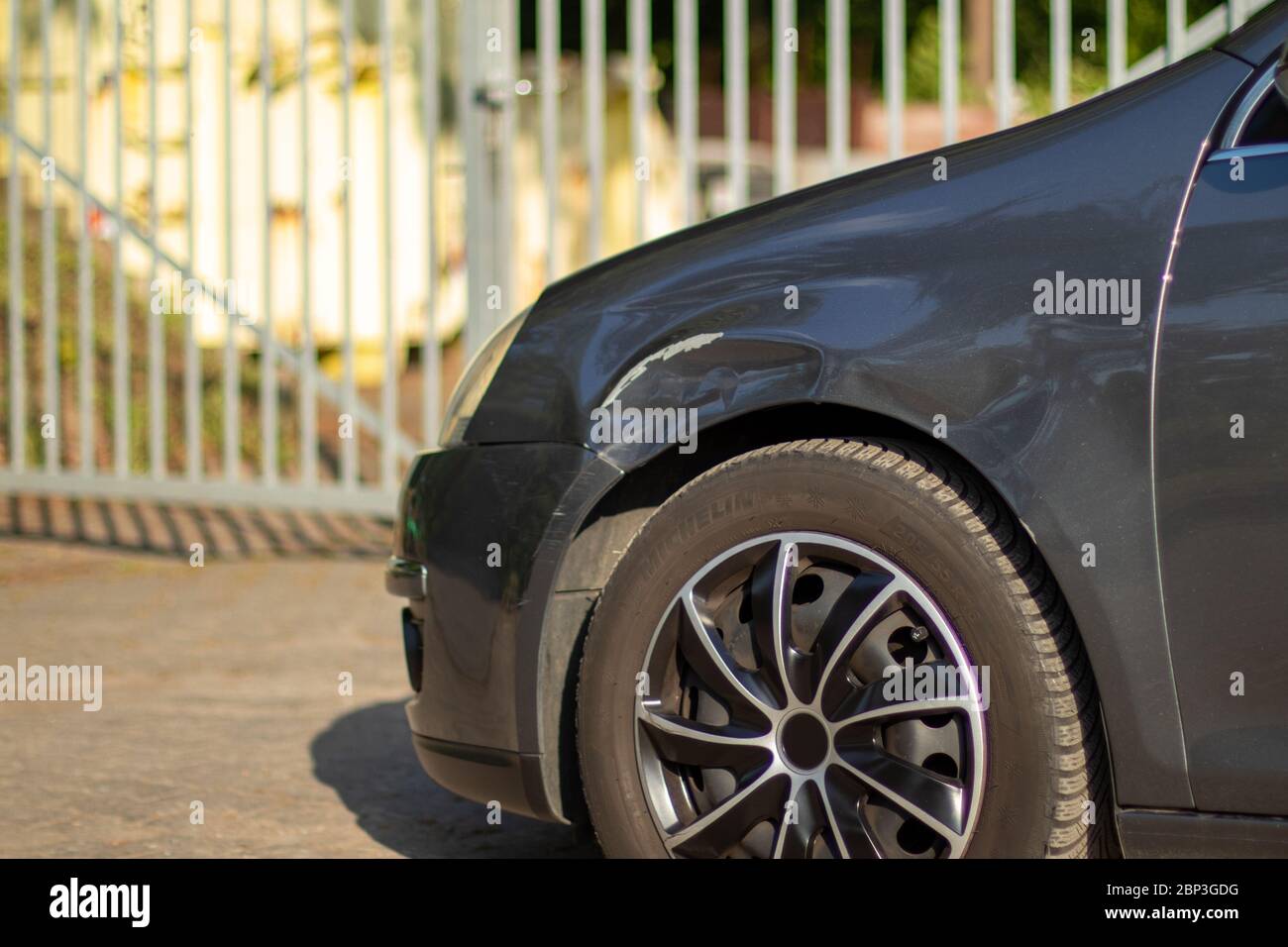 small sheet metal damage on the fender of a car, blurred background ...