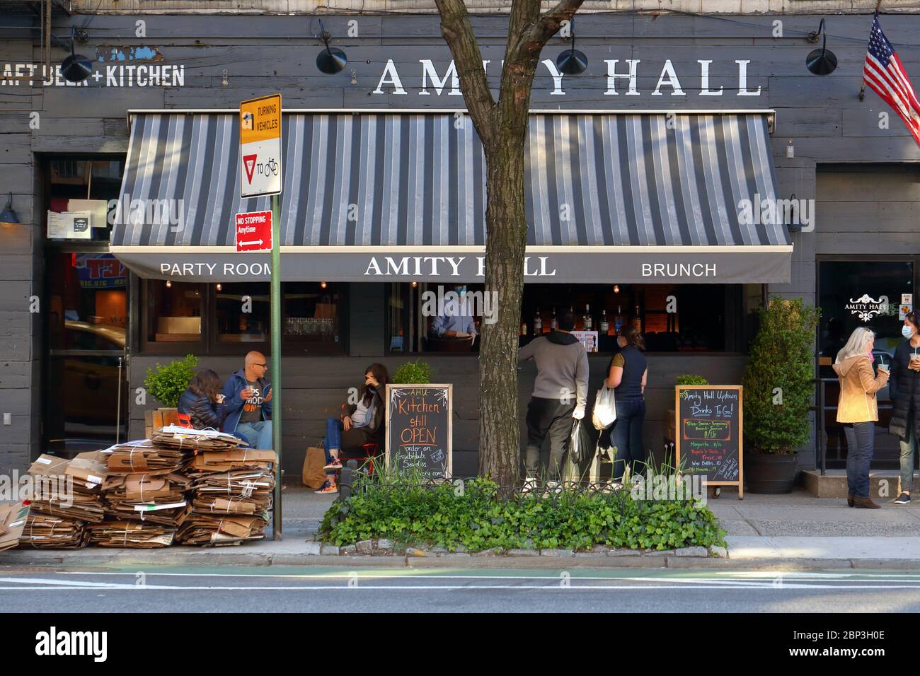 The scene outside Amity Hall restaurant in New York open for take-out ...